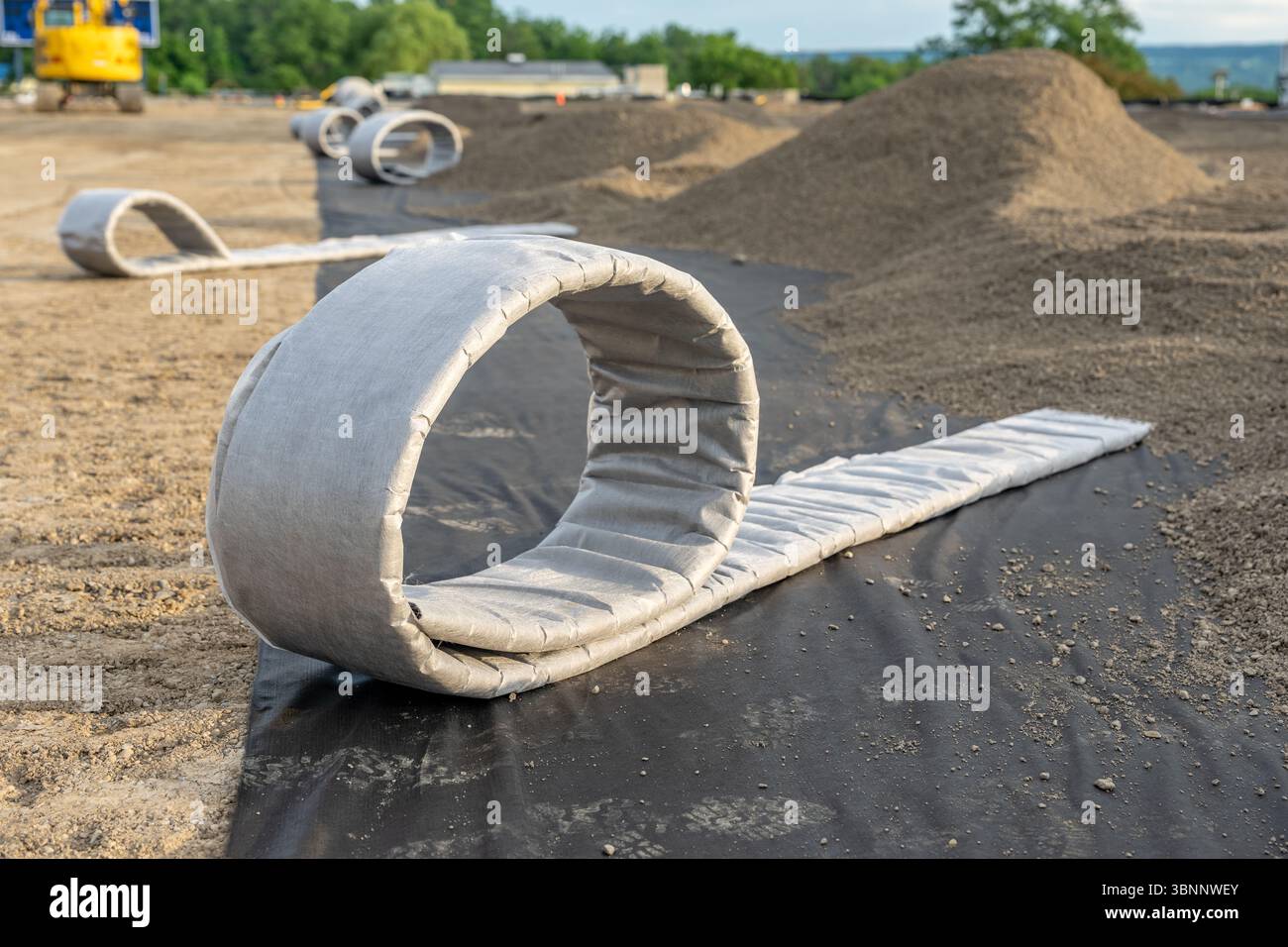 Construction photo of a roll of flat panel drainage pipe being ...