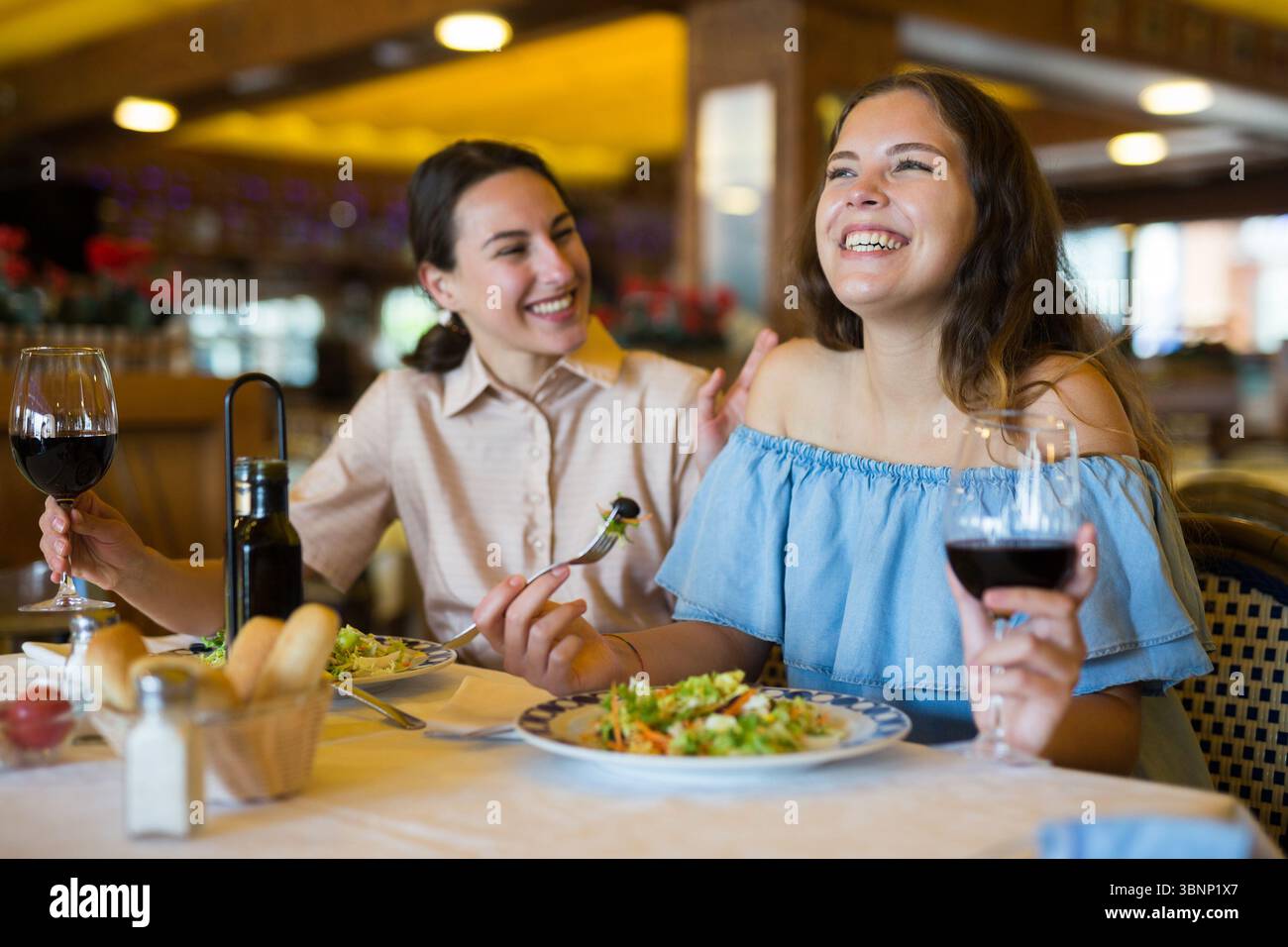 Two best friends have fun talking at a table in restaurant Stock Photo ...