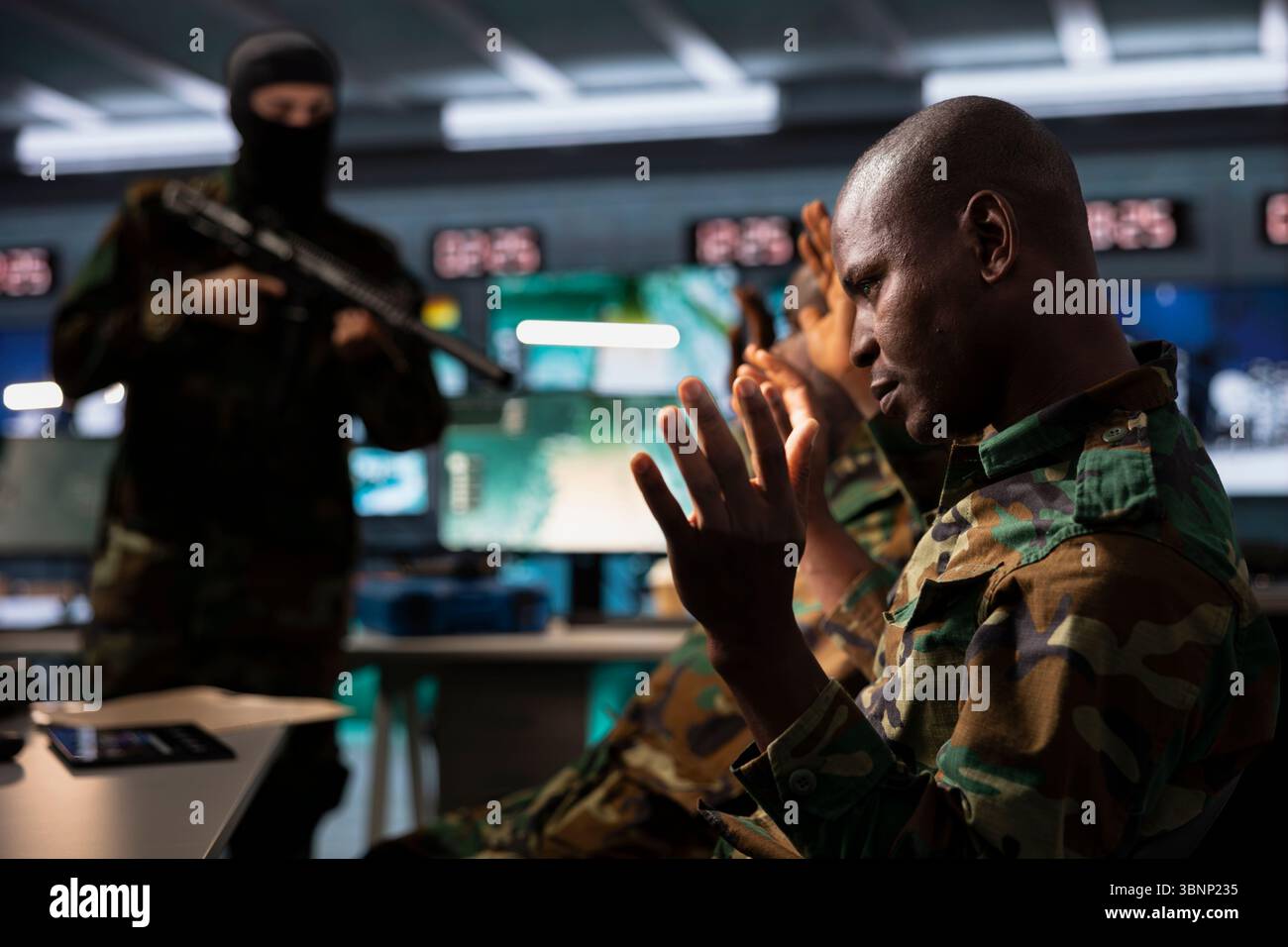 Focus on army hostages at the mercy of terrorist holding assault rifle ...