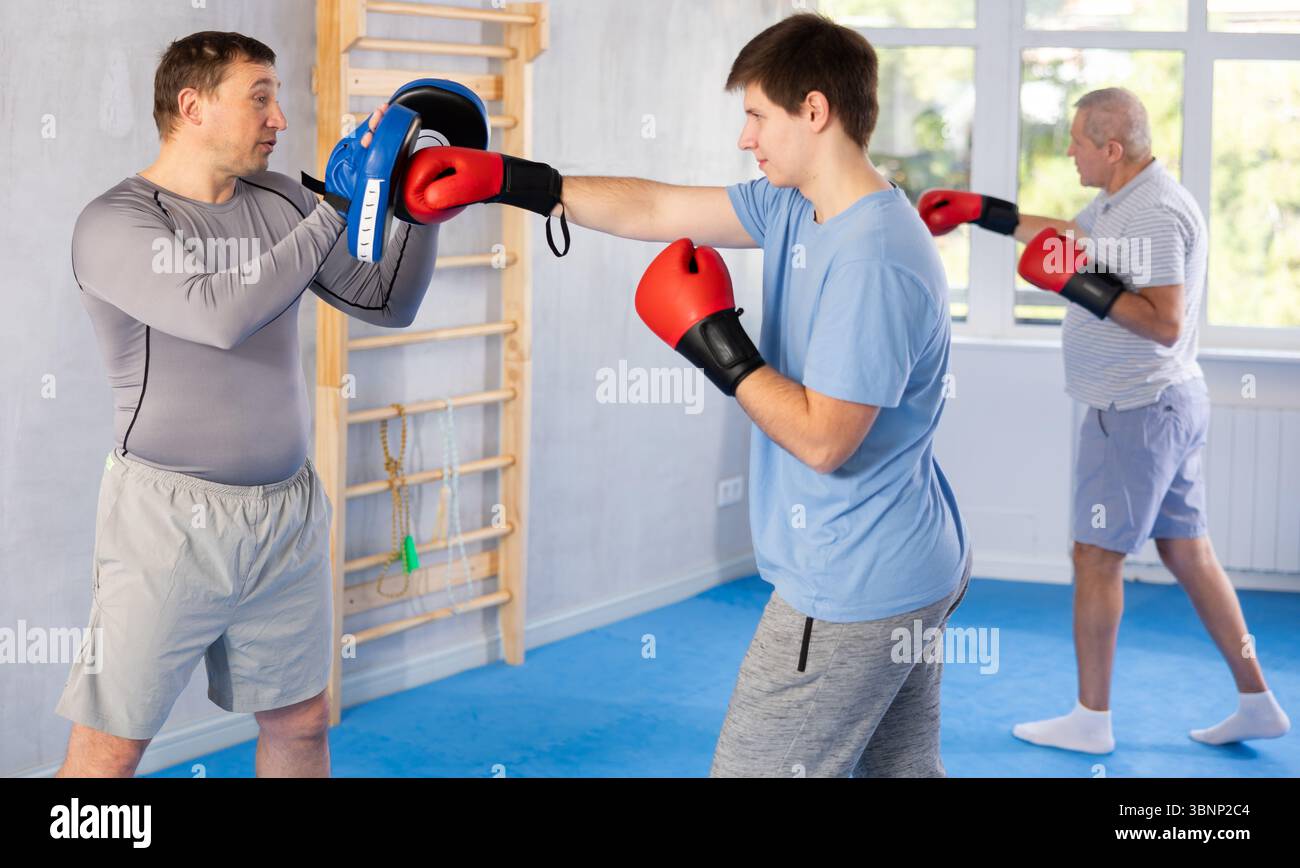 Two men training boxing fight in studio Stock Photo - Alamy