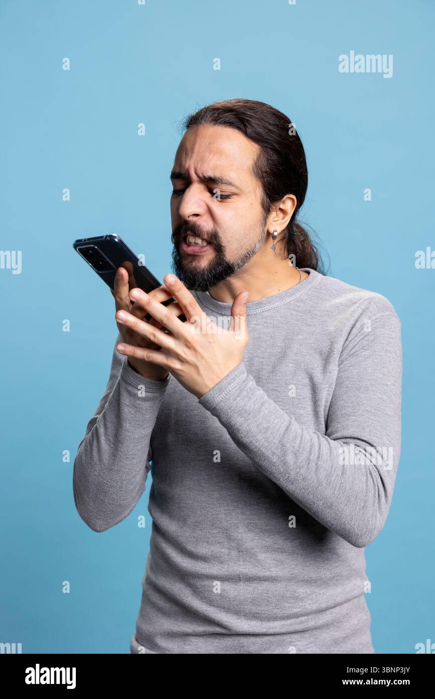 Young person having a furious reaction after receiving bad news on ...