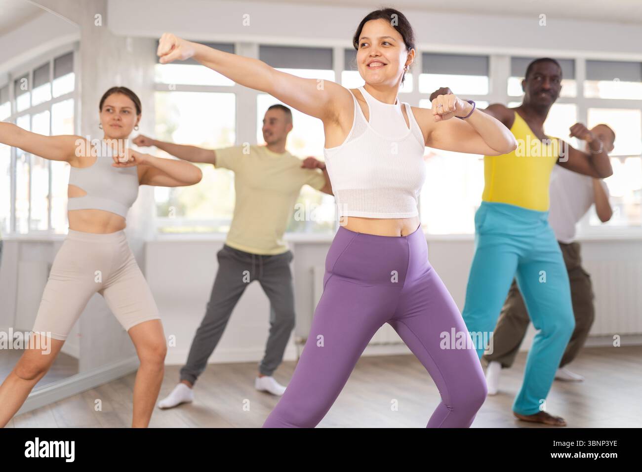 Asian girl practices kicking and punching in process of self-defense at ...
