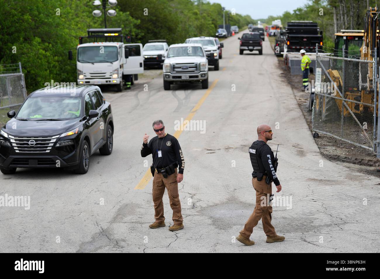 Police man the entrance to a new migrant detention facility at Dade ...