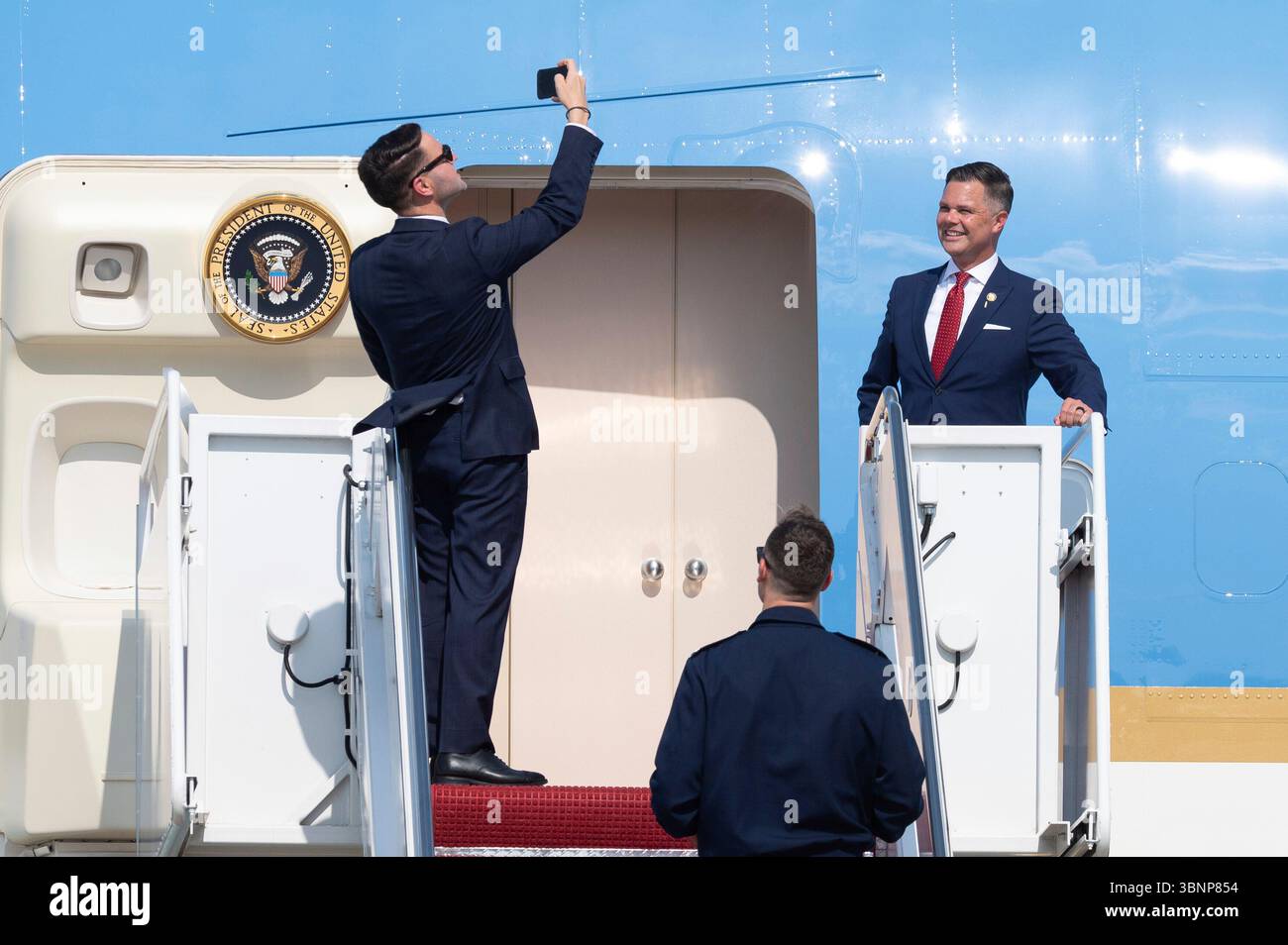 Rep. Zach Nunn, R-Iowa, right, has his photo made as he boards Air ...