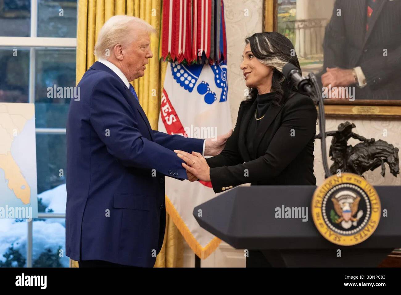 President Donald Trump congratulates Tulsi Gabbard after she is sworn ...