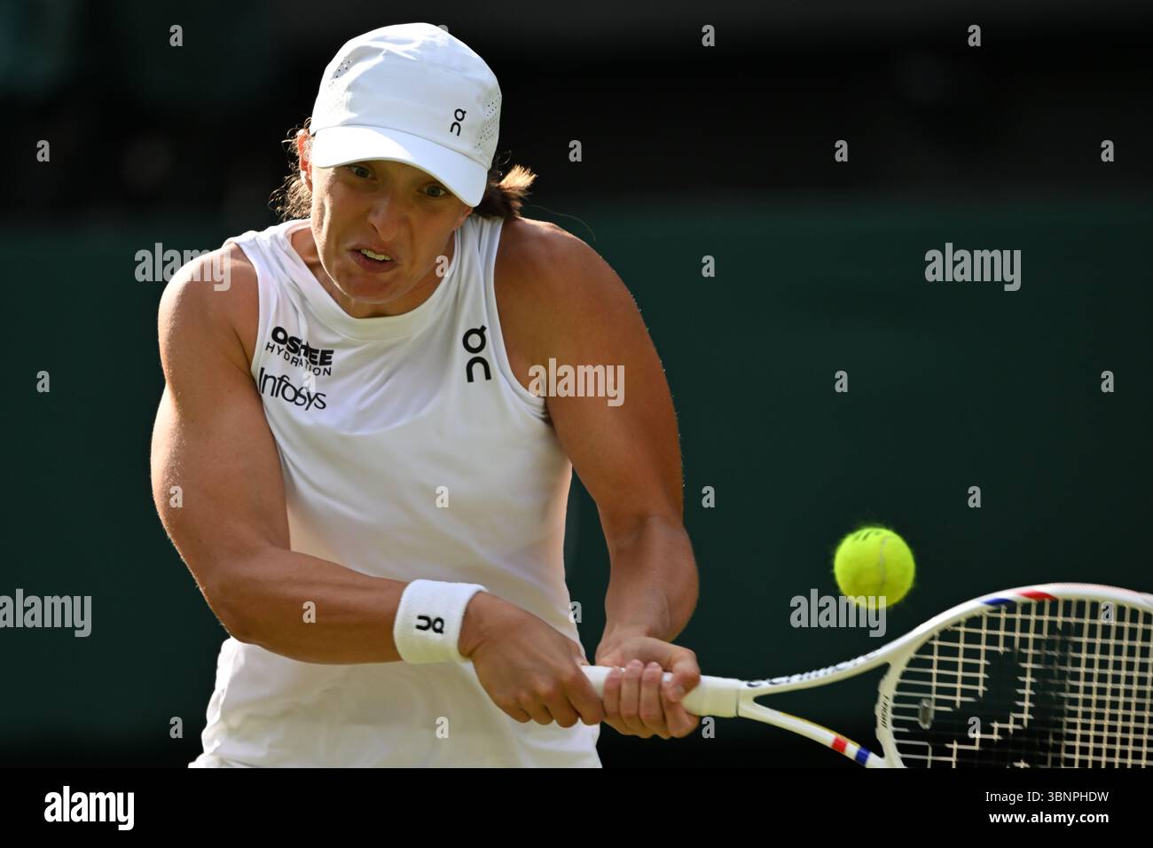 London, Britain. 3rd July, 2025. Iga Swiatek hits a return during the ...