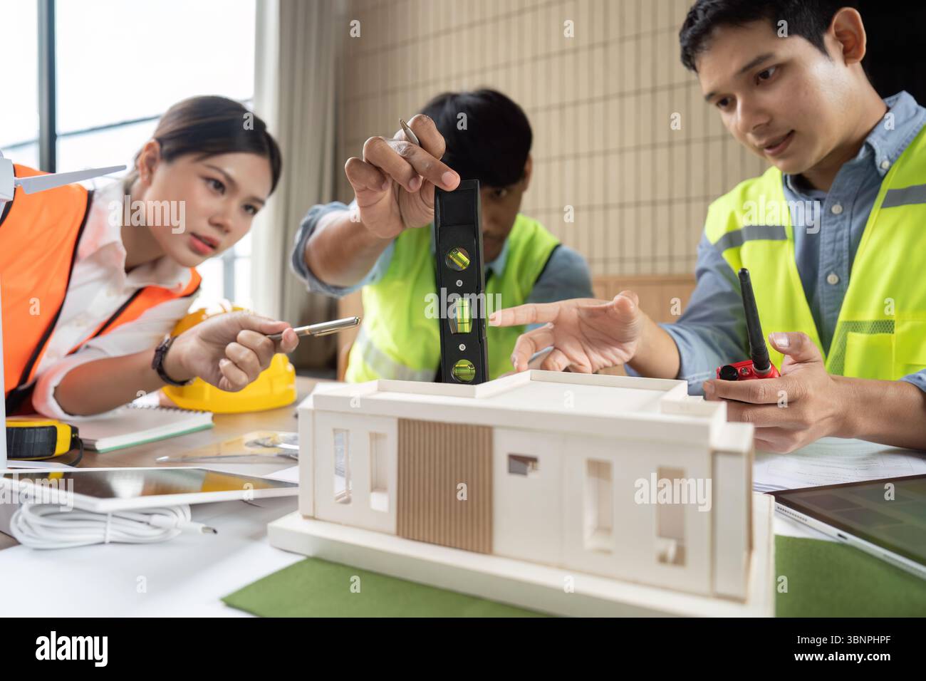 Engineers measuring model for sustainable construction project Stock Photo - Alamy