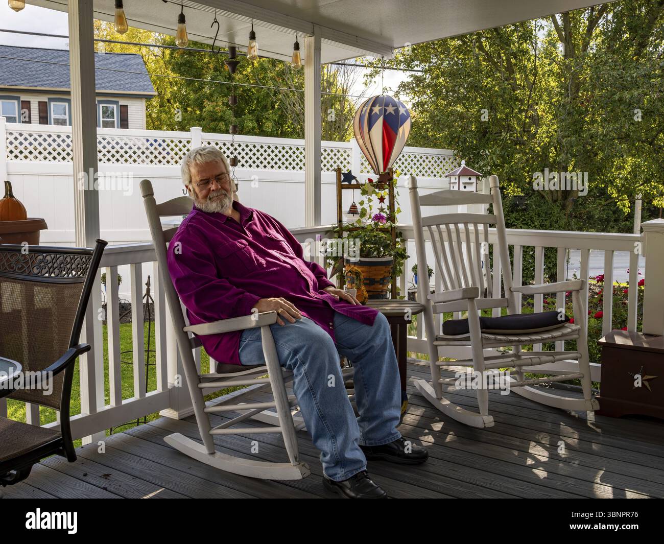 A Senior Aged Male Sleeping in a Rocking Chair, on a Deck, Enjoying His ...
