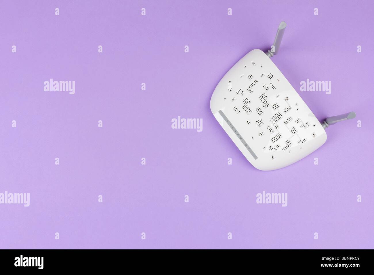 New white Wi-Fi router with gray antennas on a light purple background ...
