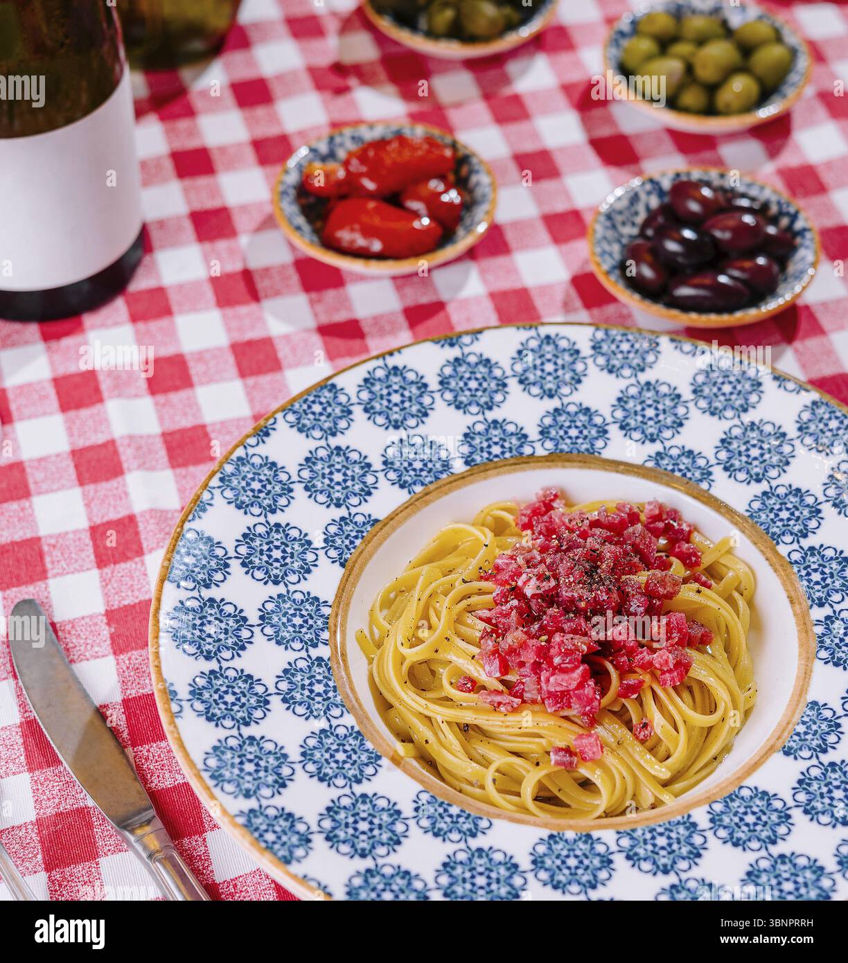 Pasta spaghetti with different types of olives and wine Stock Photo - Alamy