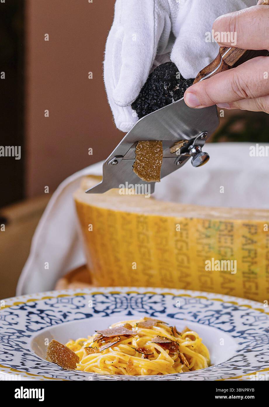 Chef Grating Truffle Shavings on Pasta with Parmesan Stock Photo - Alamy