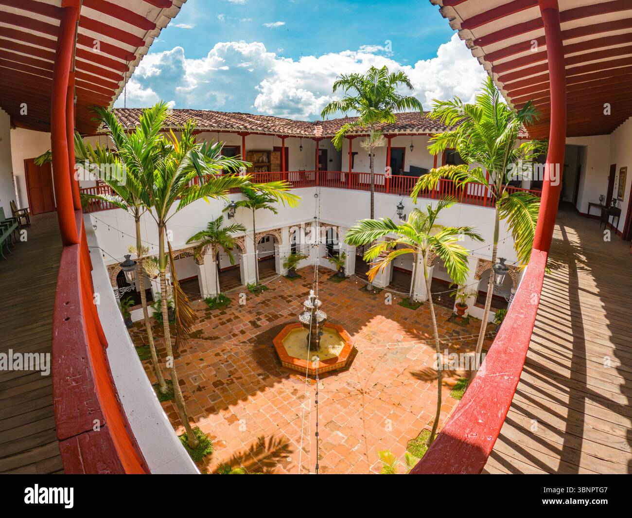 Beautiful colonial courtyard featuring lush greenery, traditional ...
