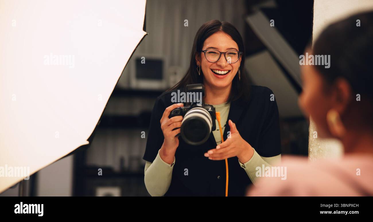 Woman, photographer and smile with camera on set for photoshoot ...