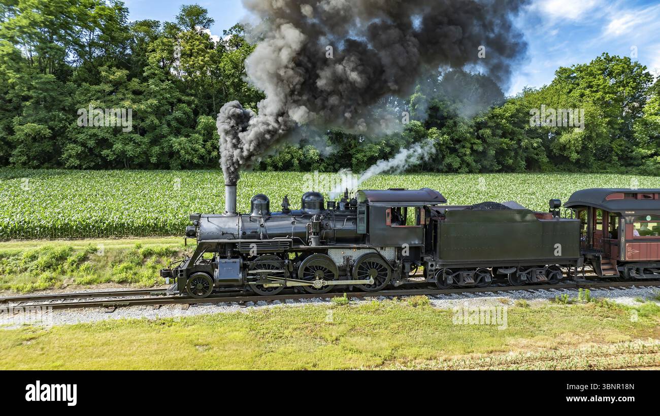 A Black Steam Locomotive Numbered 89, Puffing Thick Smoke, Travels ...