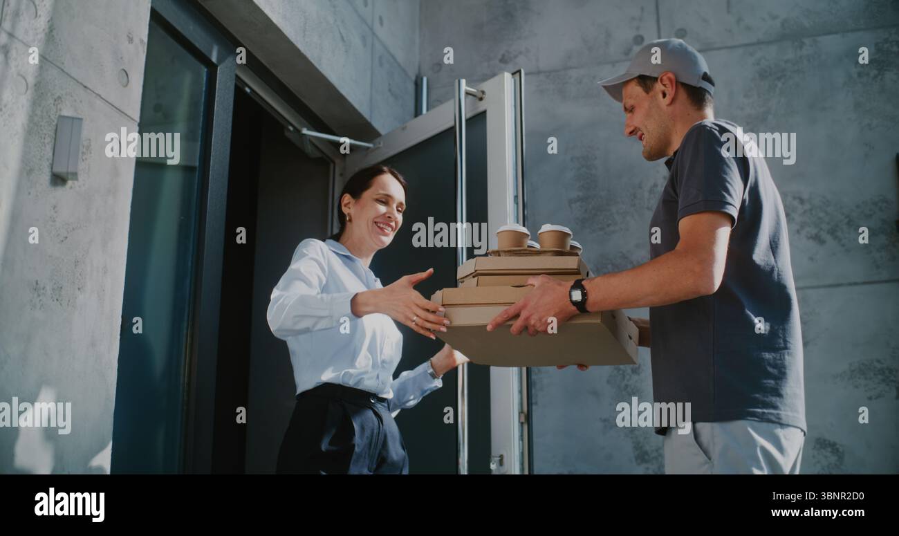 Happy Businesswoman Taking Coffee and Pizza from Delivery Service ...