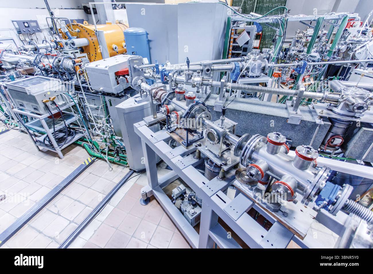 Wide view of hadron collider lab with particle accelerator system and ...