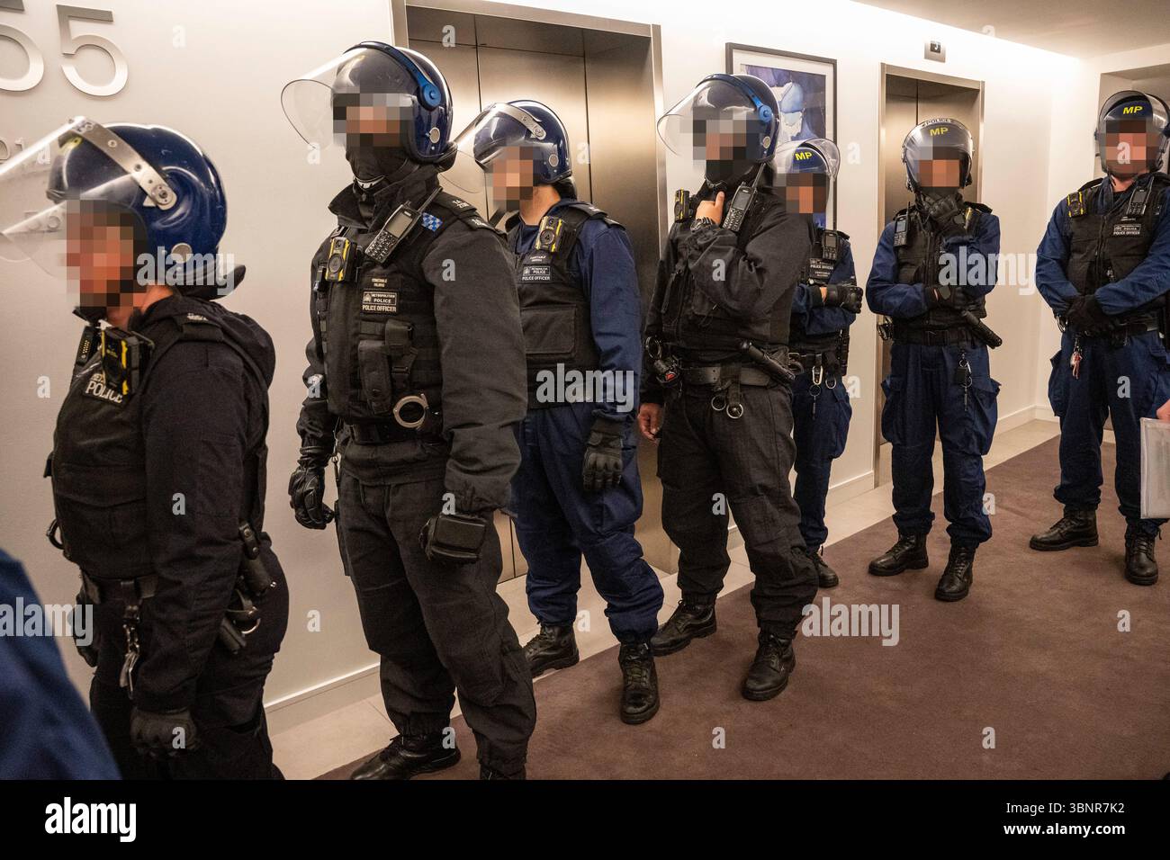 FACES PIXELATED BY PA PICTURE DESK Metropolitan Police officers carry ...