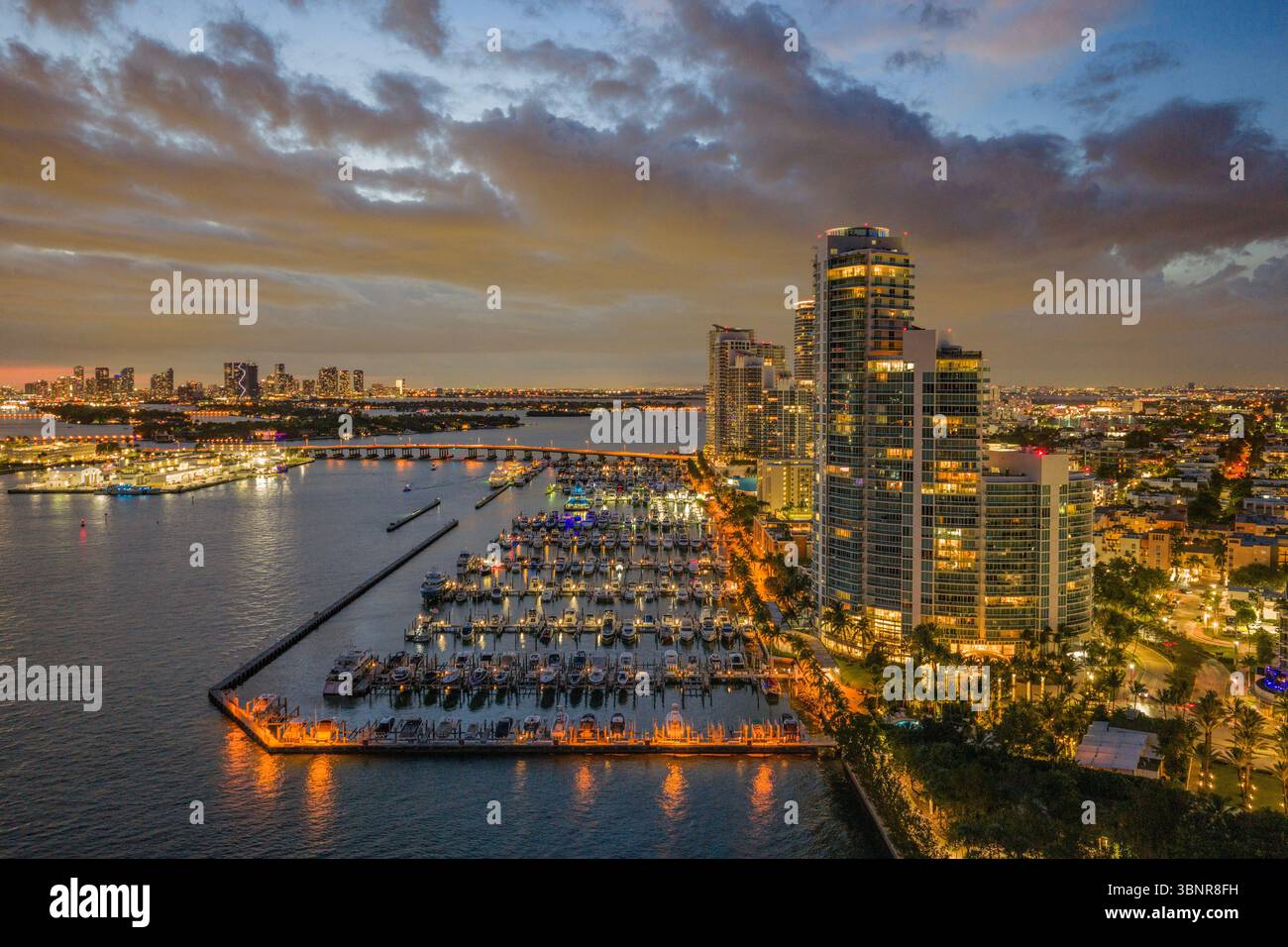 Twilight over Miami skyline and marina. Luxury yachts glowing in the ...