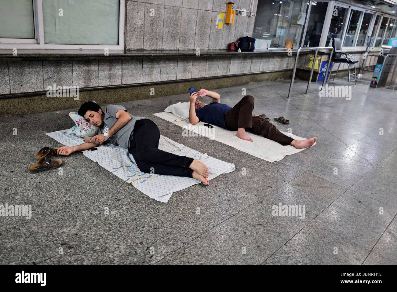 After an emergency evacuation alert, residents seek shelter in a metro ...