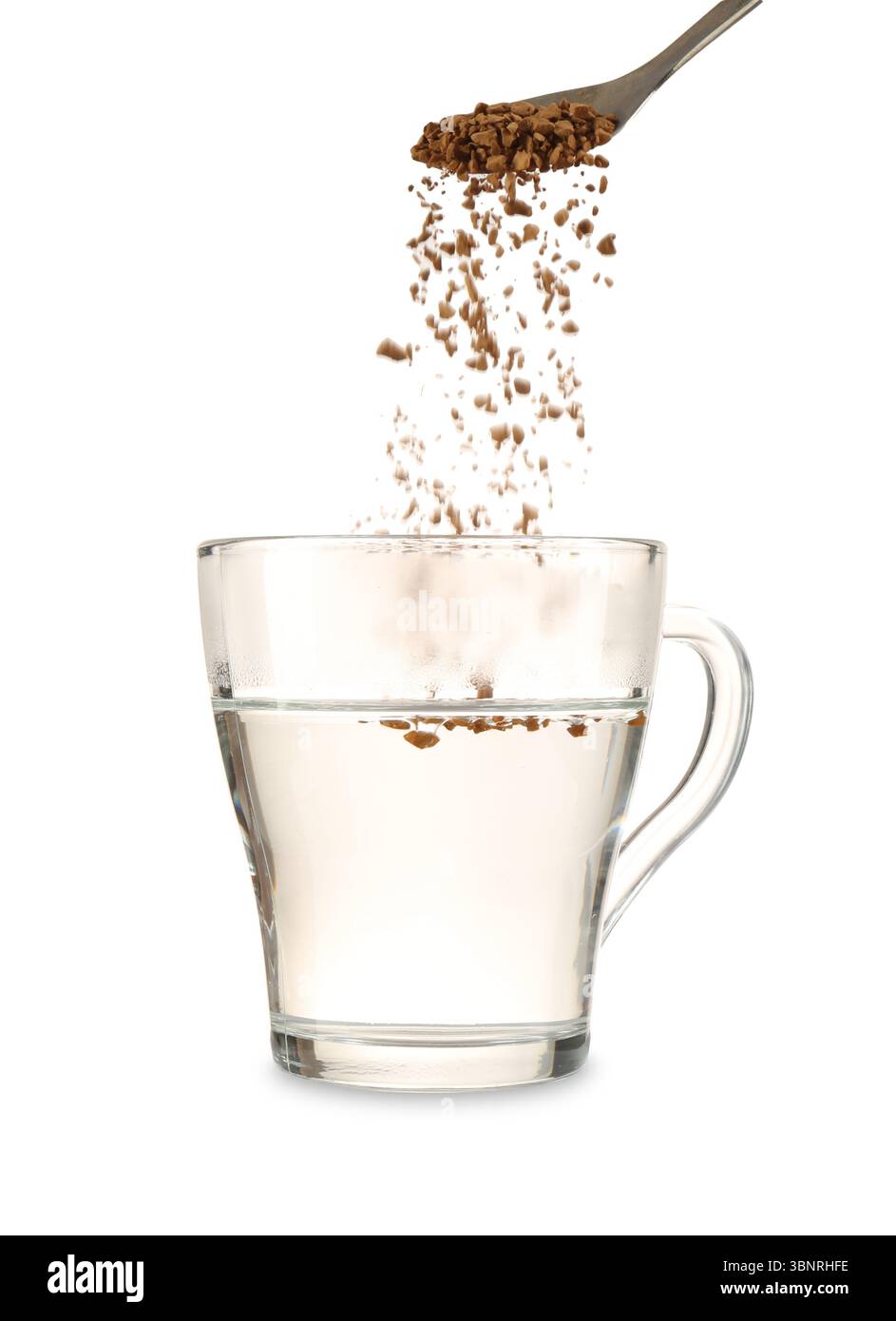 Adding granulated instant coffee from spoon into glass cup with boiled ...
