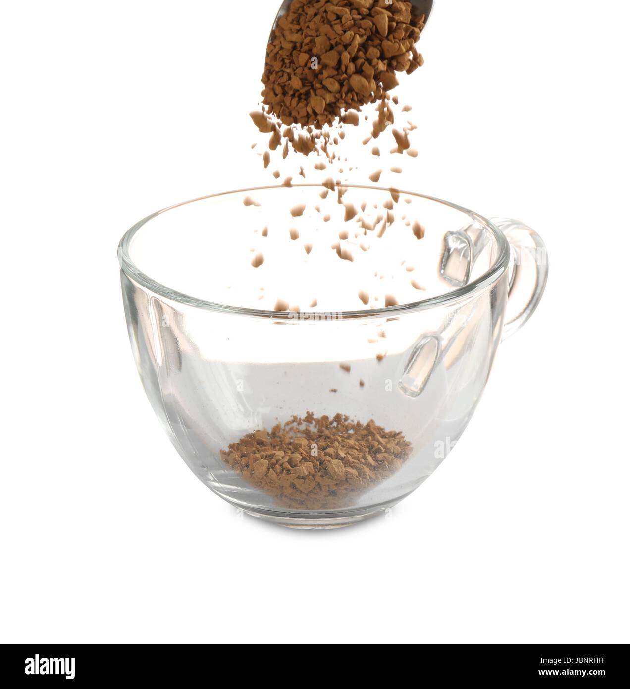 Adding granulated instant coffee from spoon into glass cup isolated on ...