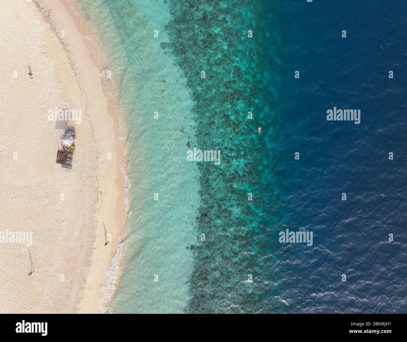Aerial view of the serene beach where the white sand meets the ...