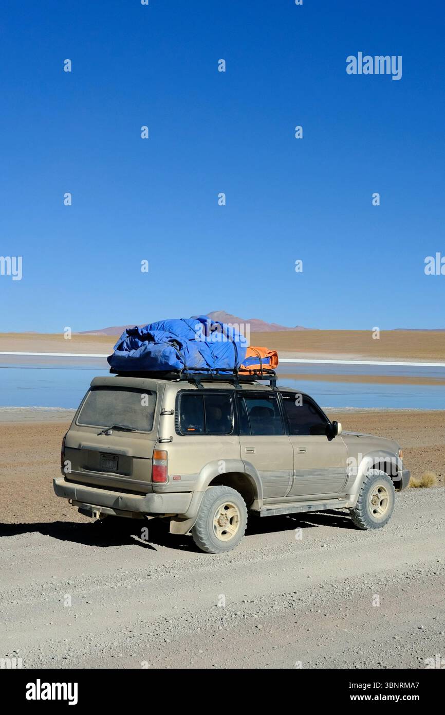 SUV Parked by Salt Flat in High-Altitude Desert Plateau Stock Photo - Alamy