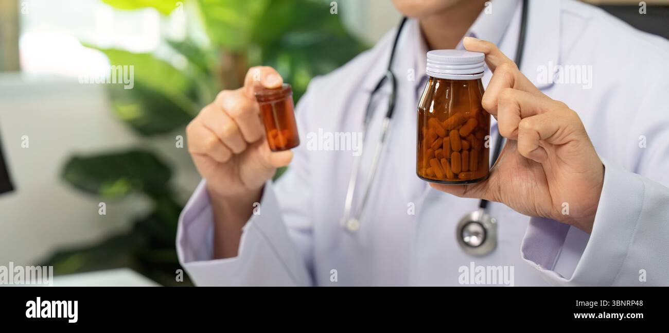 Healthcare Consultation. Doctor holding medication bottles during ...