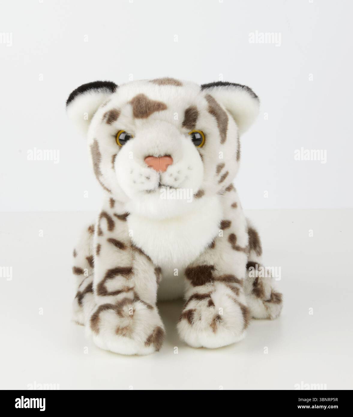 leopard doll crouching on the ground isolated nature background with ...