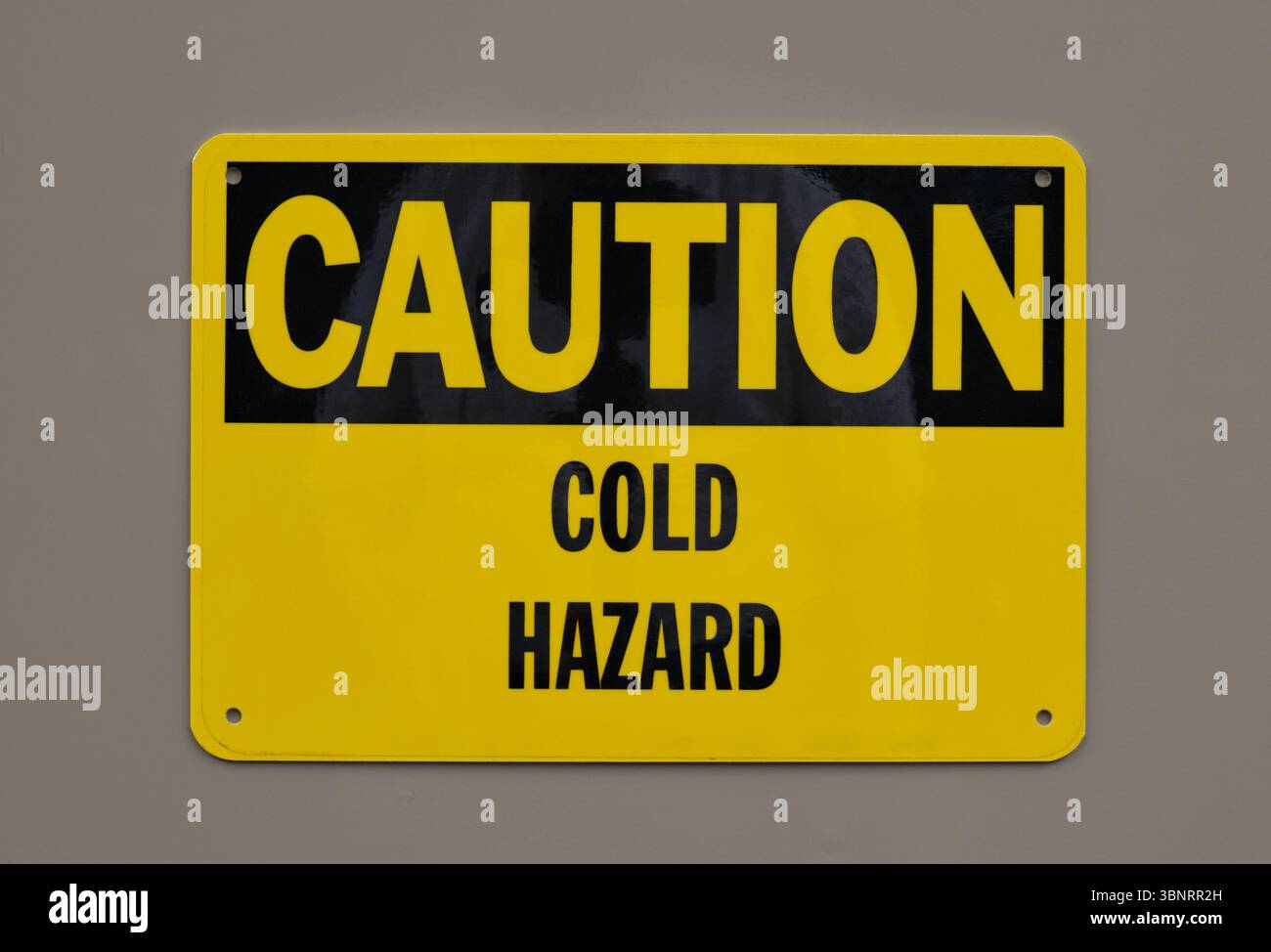 Caution Cold Hazard safety sign warning notice on wall industrial ...