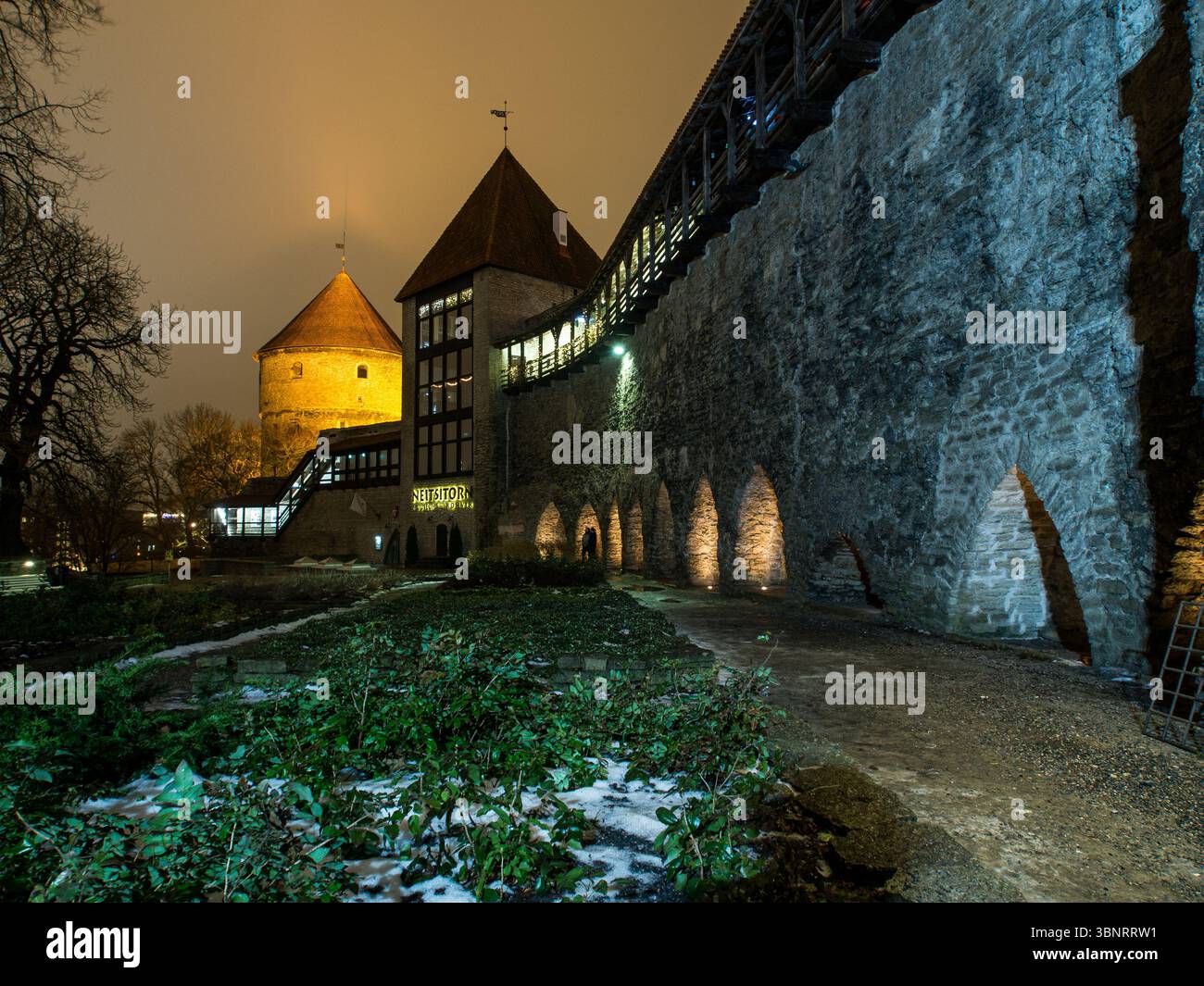 Illuminated medieval city wall and towers at night, Tallinn Old Town ...
