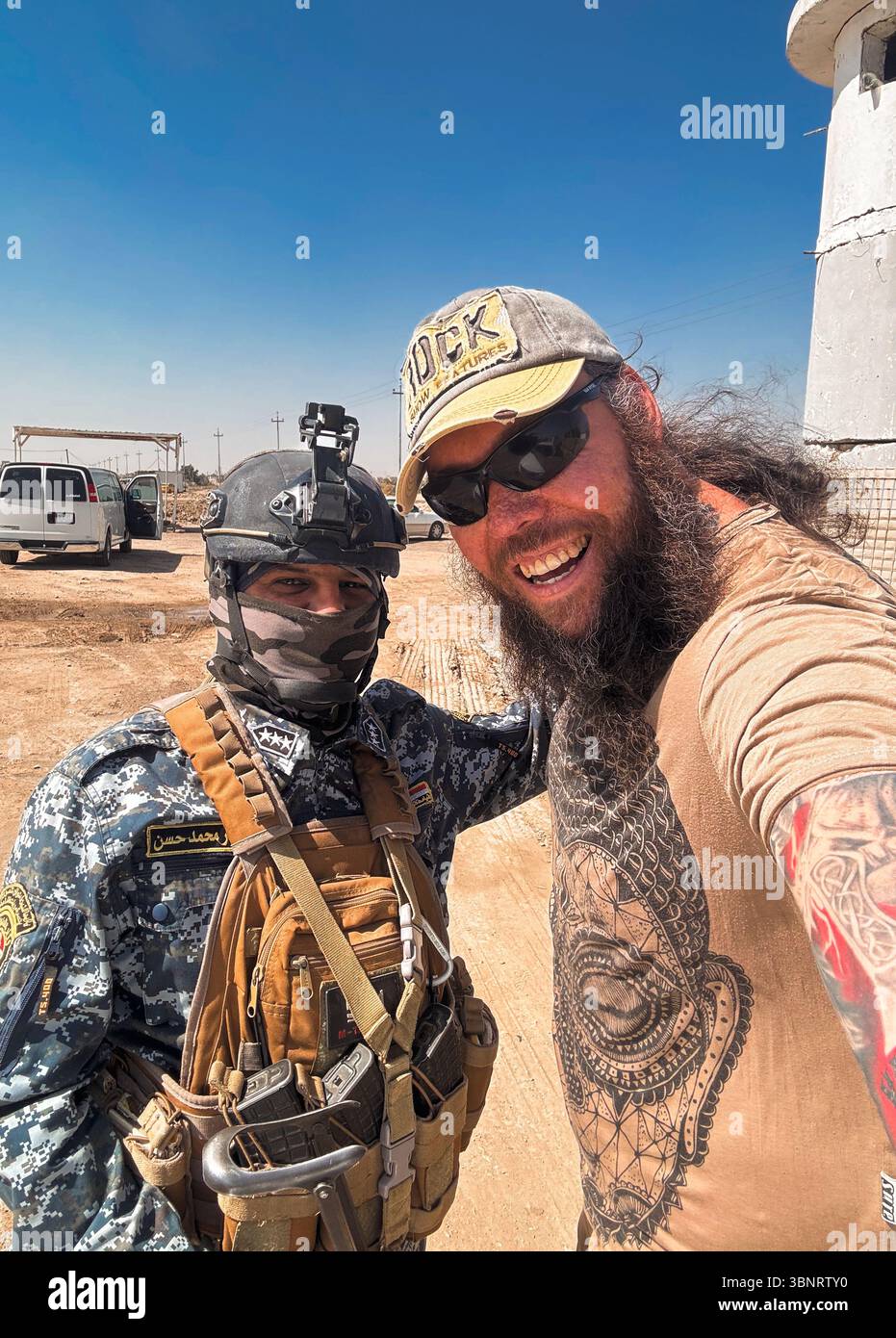 A traveler poses for a selfie with a local soldier in Iraq while ...