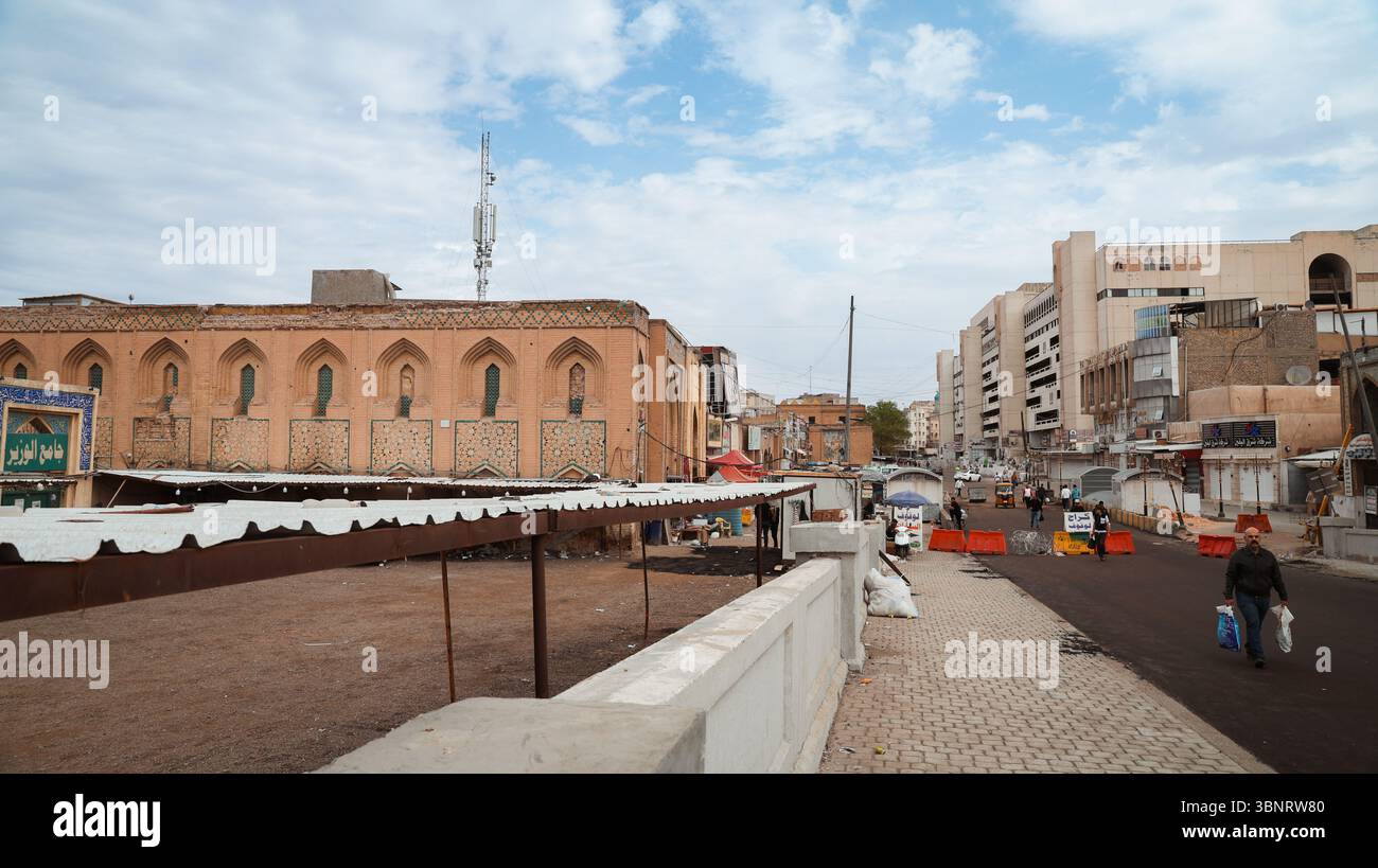 In Baghdad, Iraq, people navigate a bustling street lined with ...