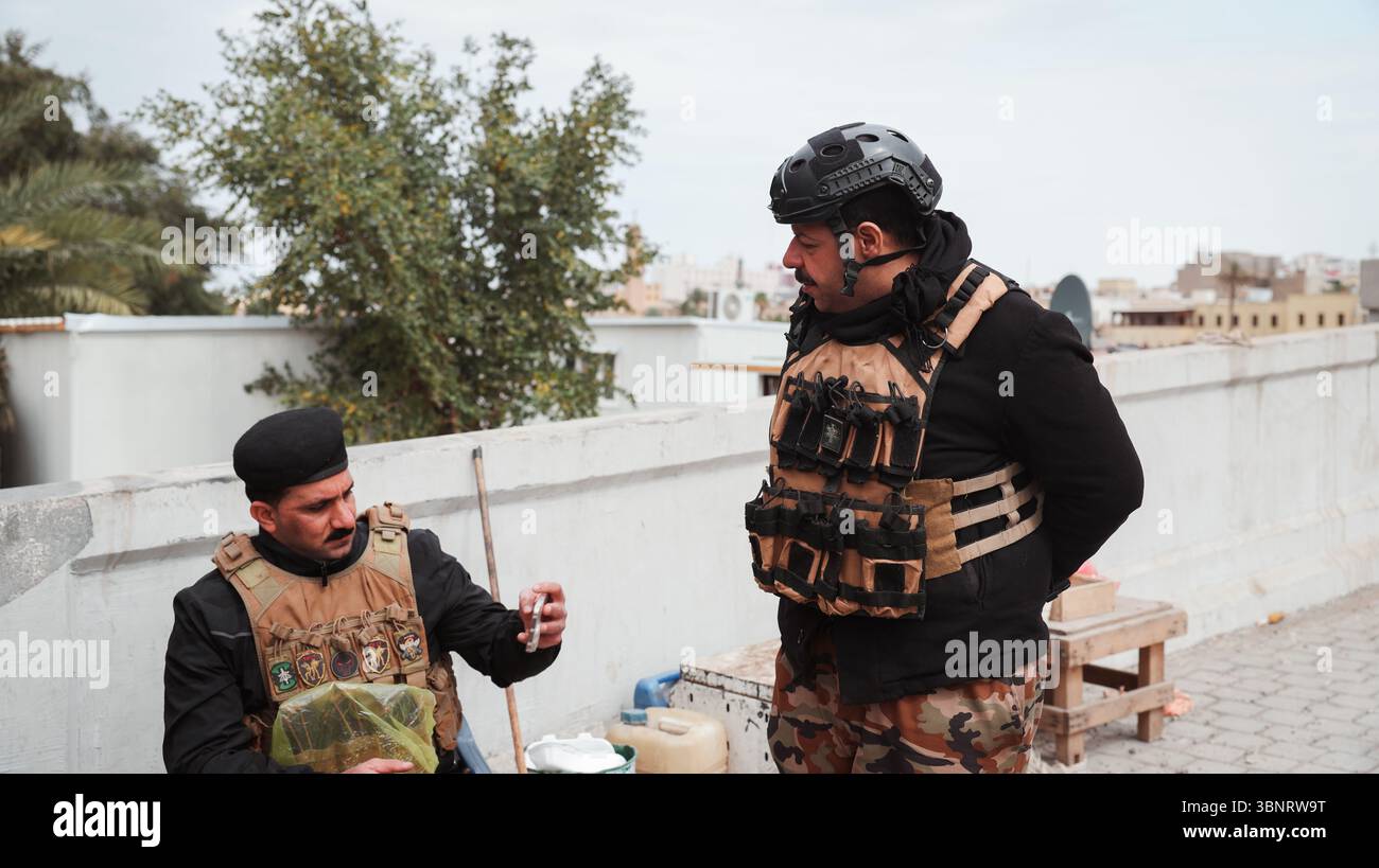 Two soldiers are engaged in a tactical discussion in Baghdad Iraq ...