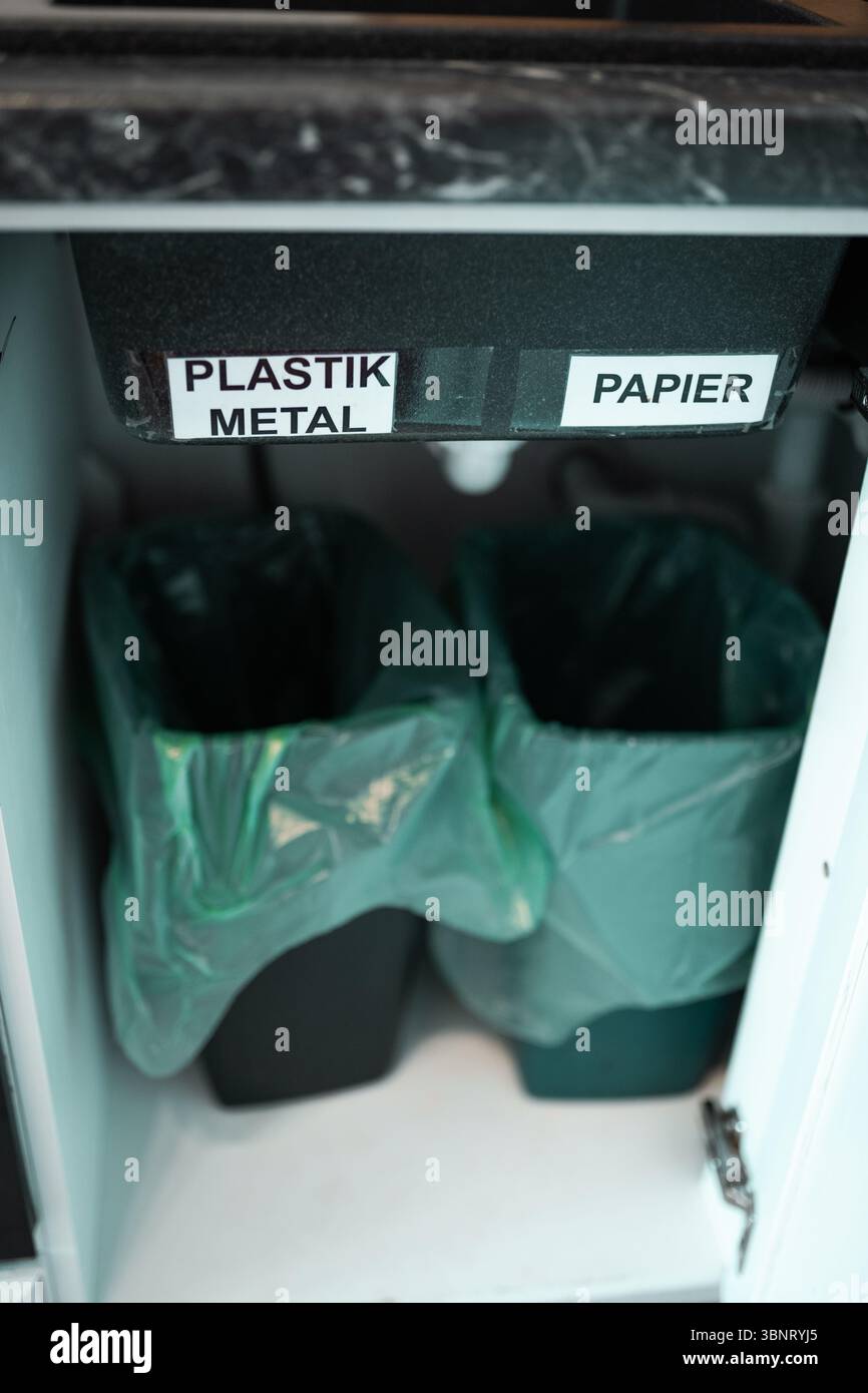 Sorting trash bins at home. Household waste sorting in the kitchen ...