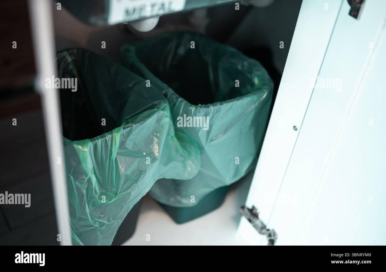 Sorting trash bins at home. Household waste sorting in the kitchen ...