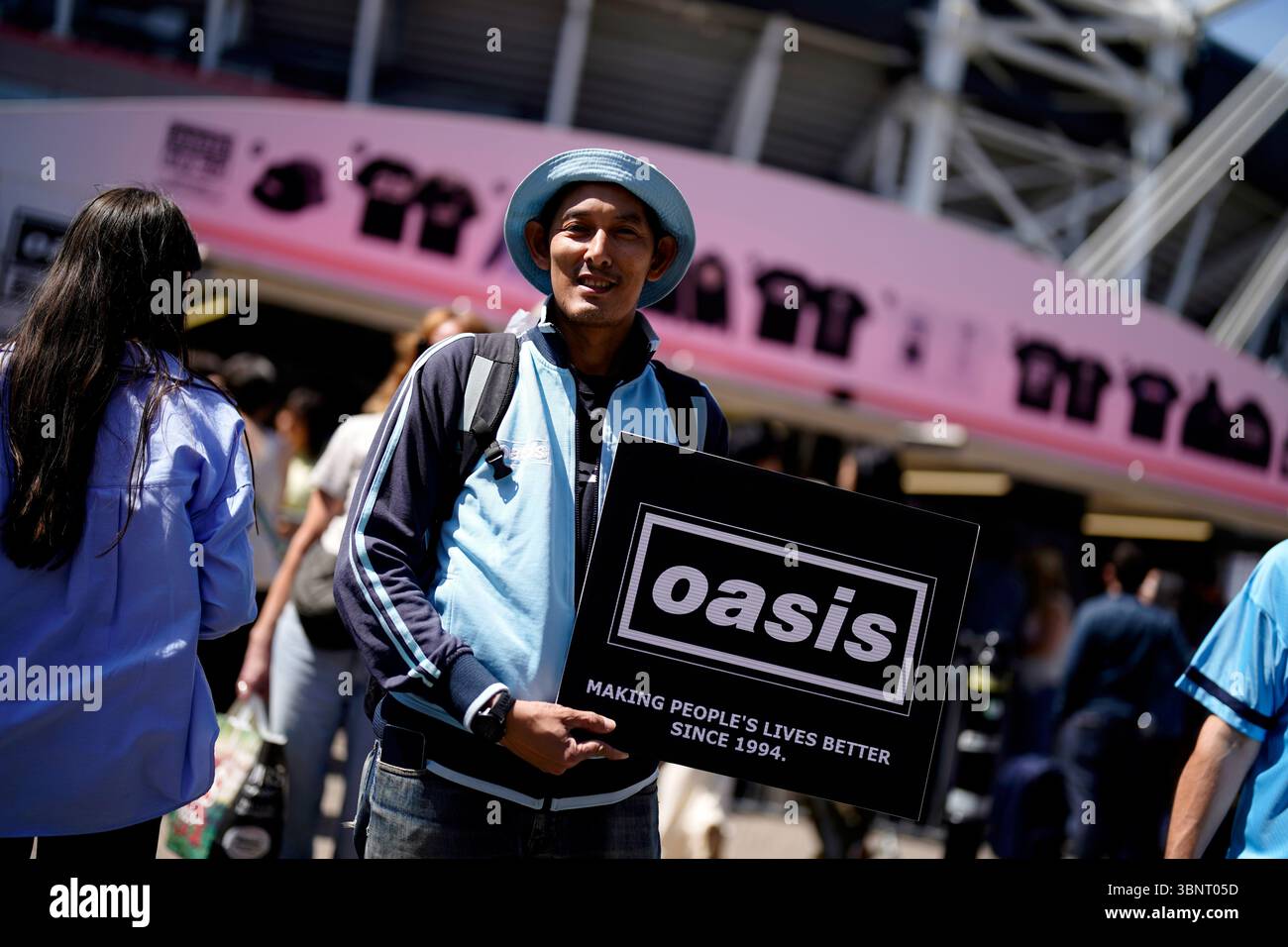 An Oasis fan holds up his sign outside the Principality Stadium ...