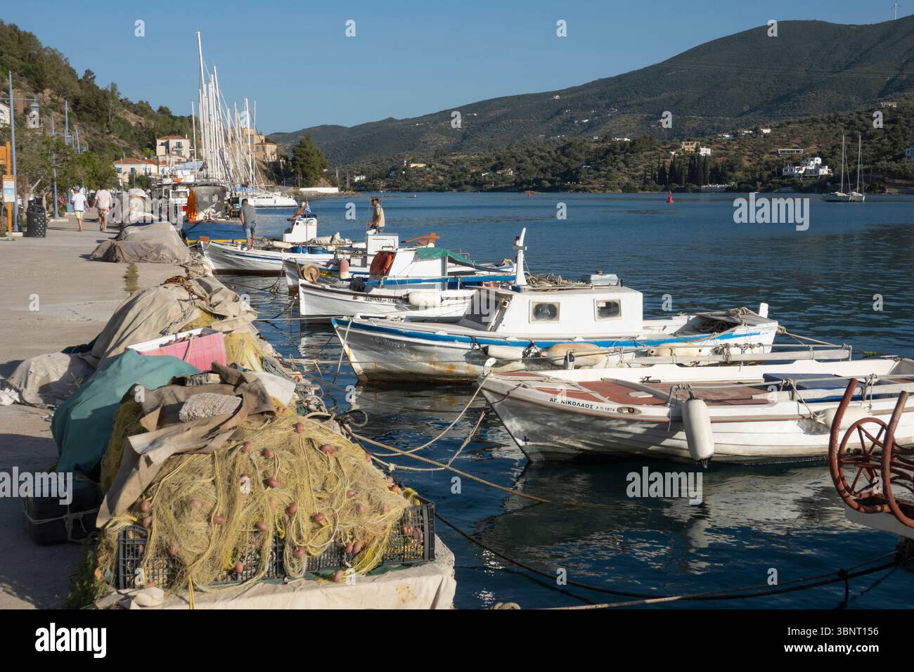 Fishing boats and nets along the harbour of Poros Town, Poros, Saronic ...
