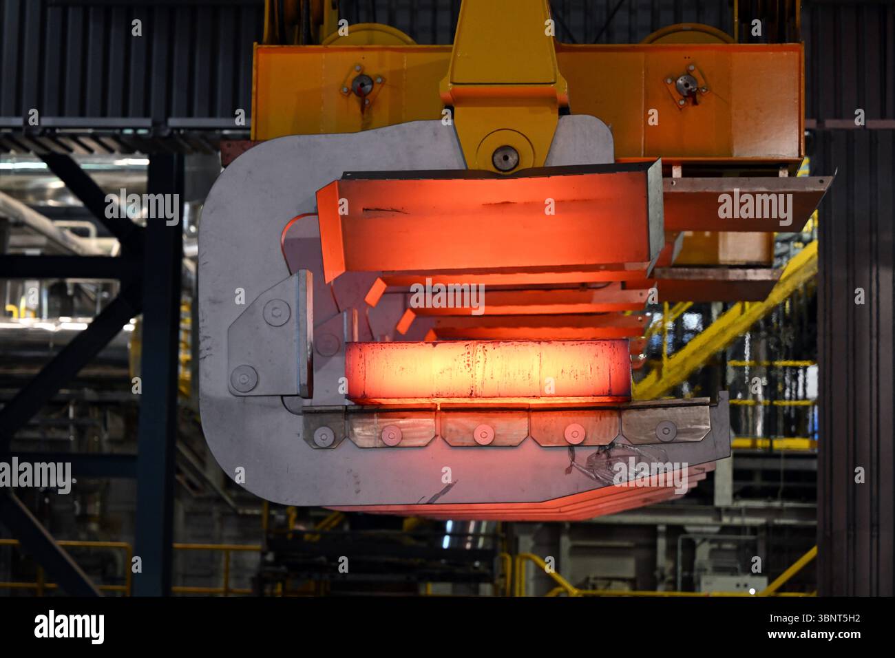 Duisburg, Germany. 04th July, 2025. A red-hot slab is transported by ...