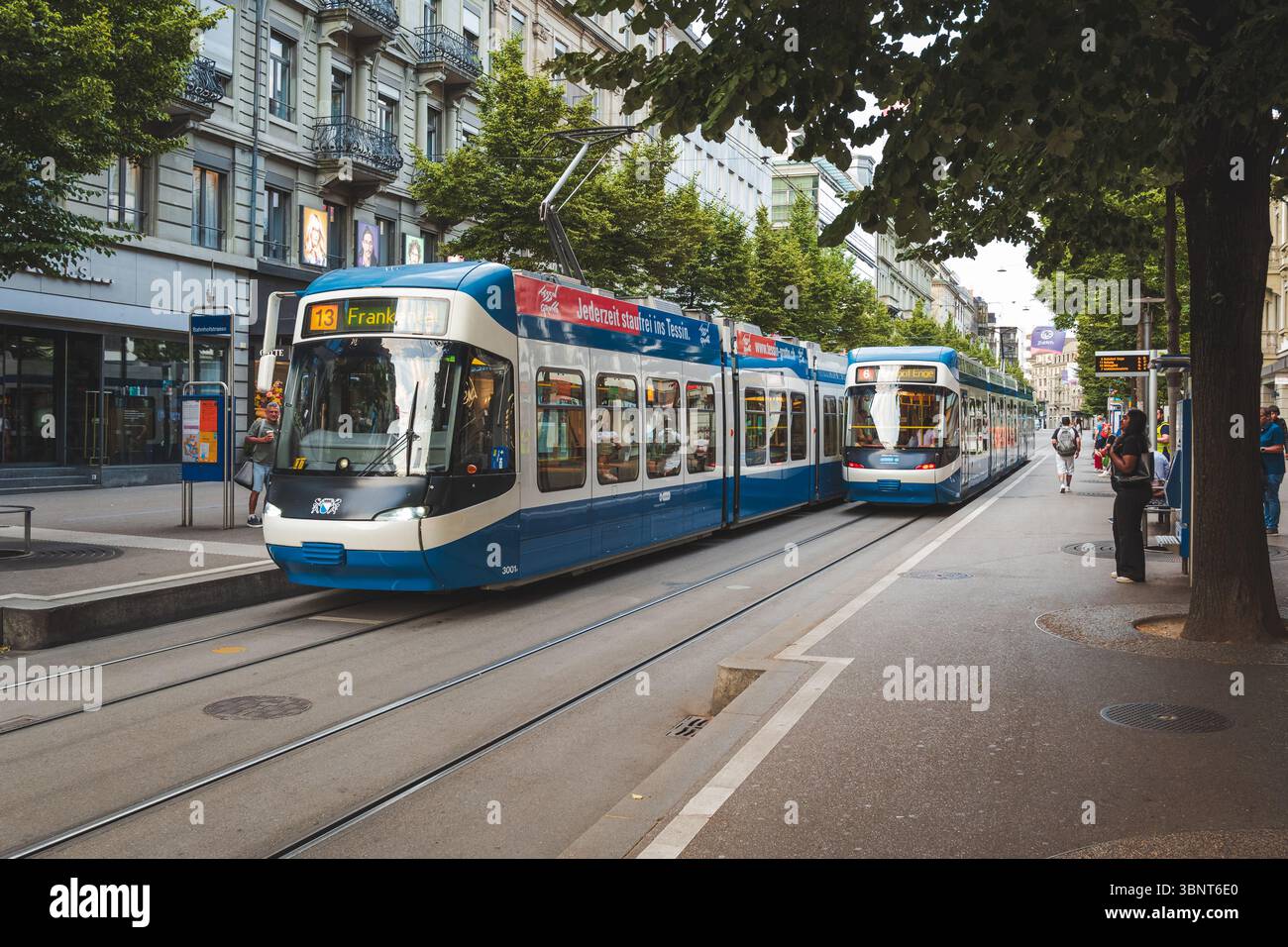 30-06-2025 Zurich, Switzerland. Tourists, commuters and trams 13 and 8 ...