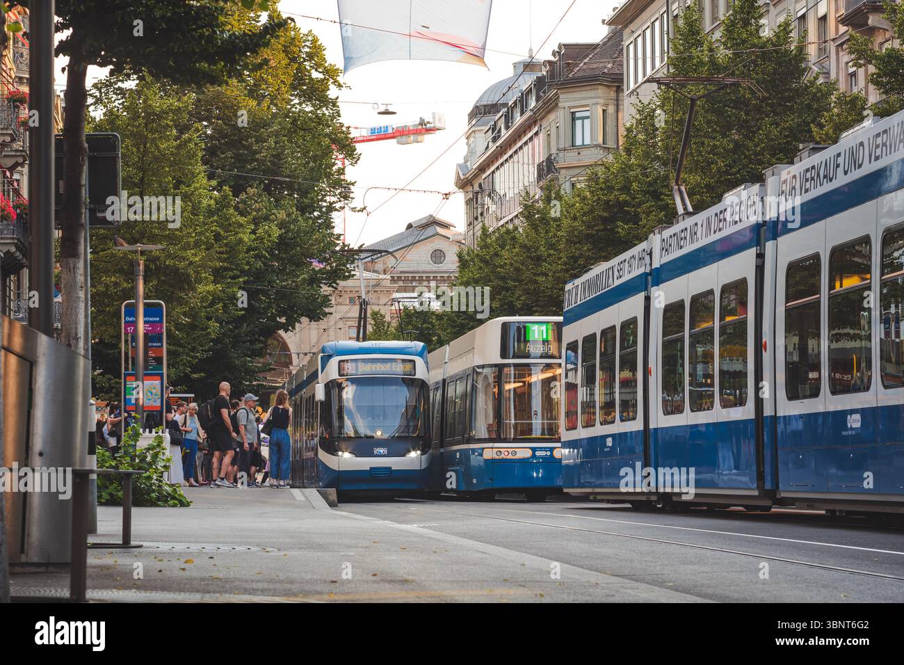 30-06-2025 Zurich, Switzerland. Tourists, commuters and trams 11 and 6 ...
