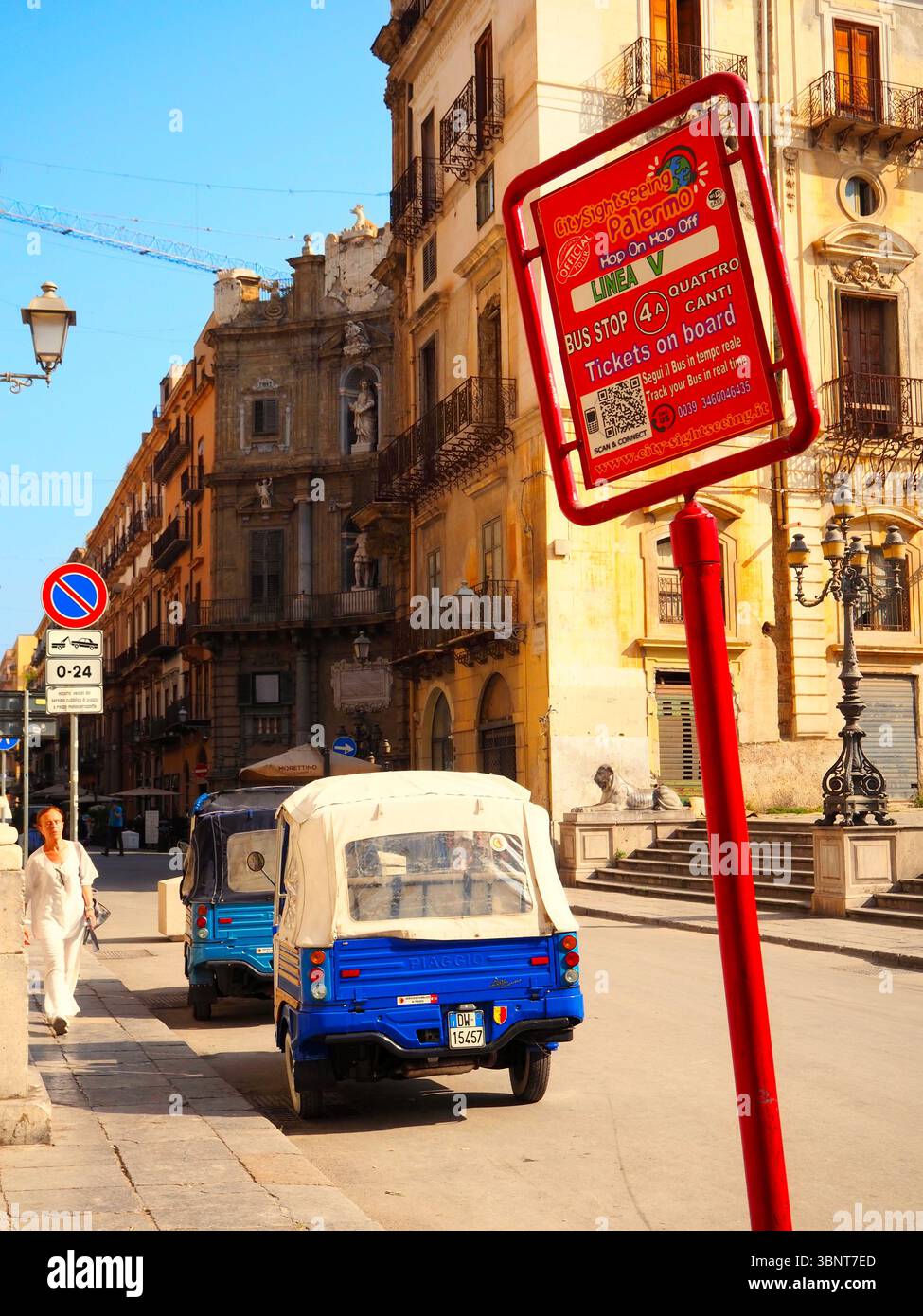 Bright red bus stop sign and tuk-tuks in the historic Quattro Canti ...