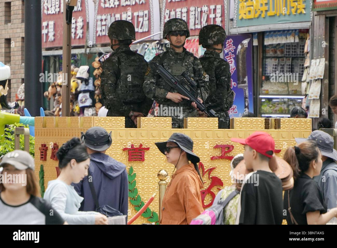 Armed police officers stand guard at the Grand Bazaar in Urumqi in ...