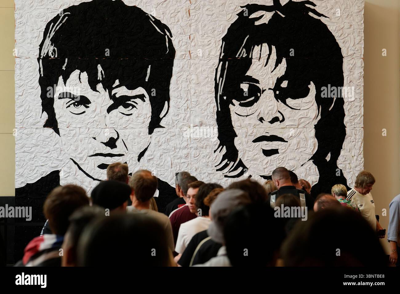 Oasis fans take photos in front of the Wonder Wall - a mural by Welsh ...