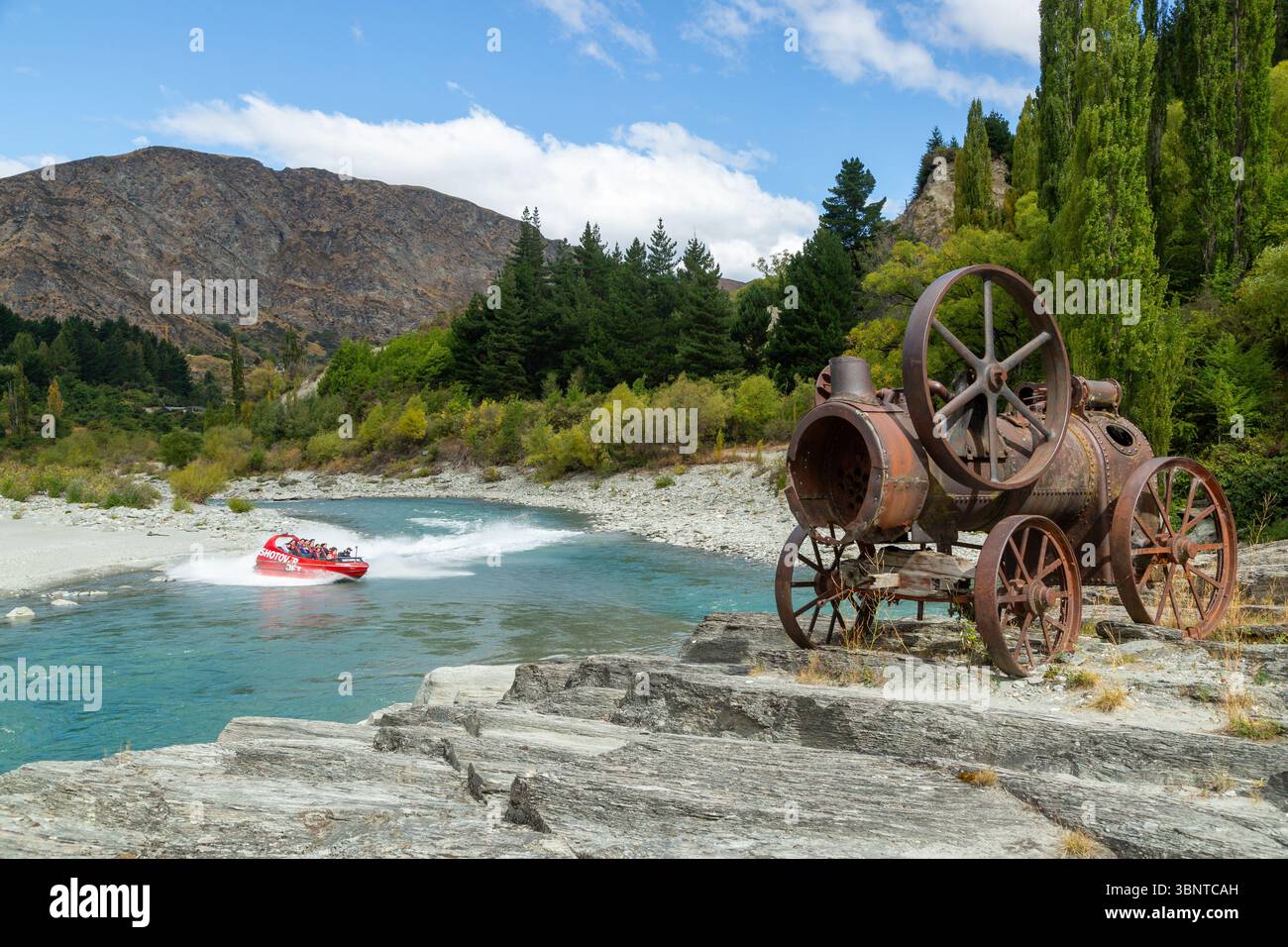 An historic steam engine with a Shotover Jet, Jet boat on the Shotover ...
