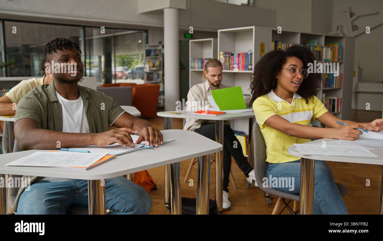 Four multiracial students studying learning education together in ...