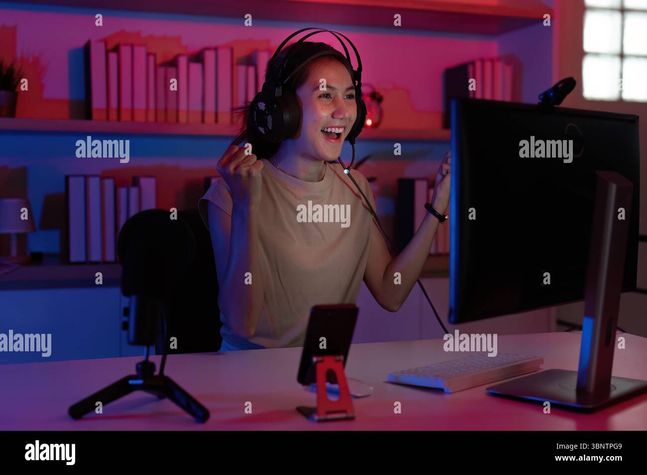 Excited female gamer celebrating hi-res stock photography and images ...