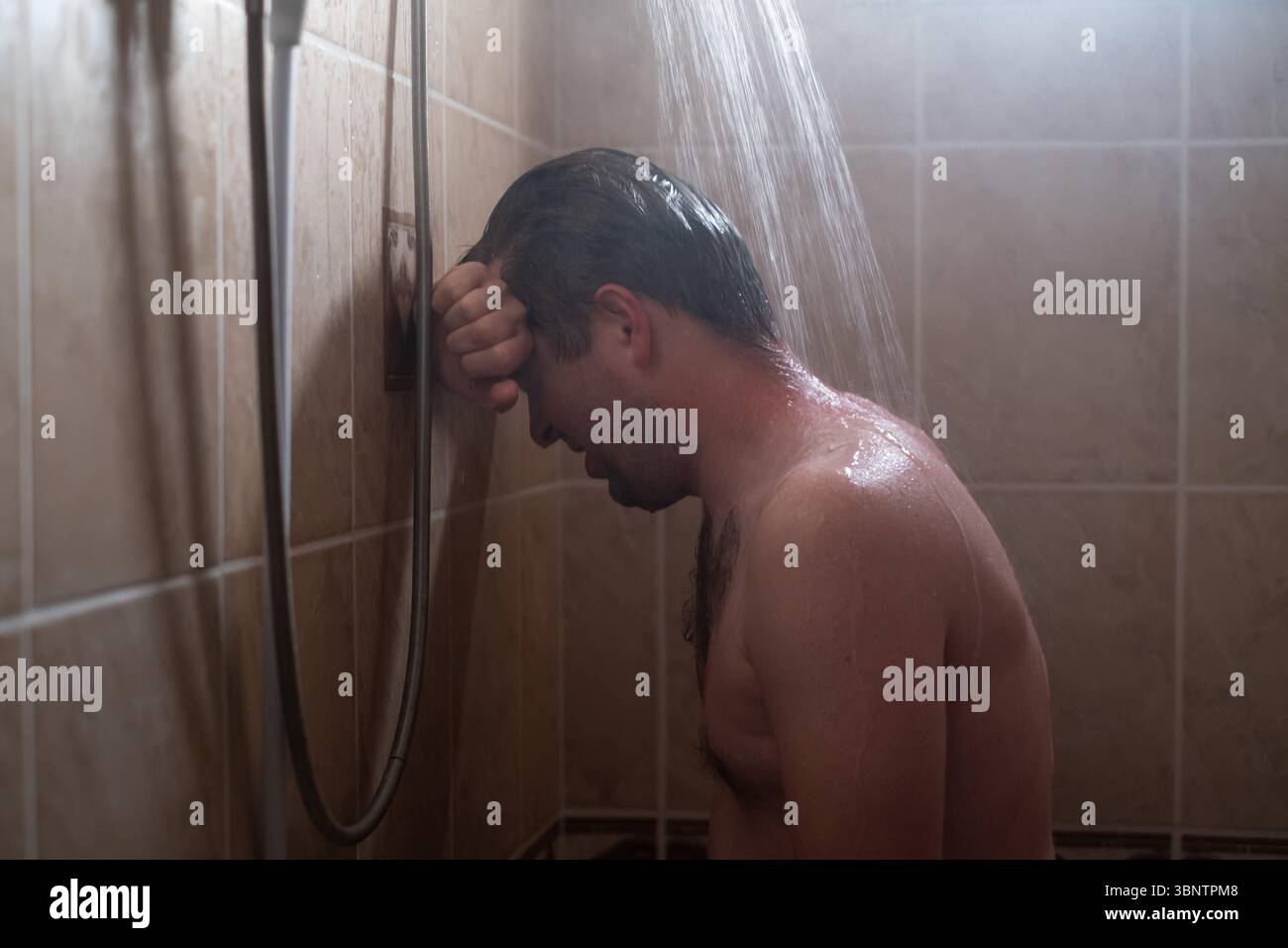 Sad Man Under Stress Taking a Shower Stock Photo - Alamy