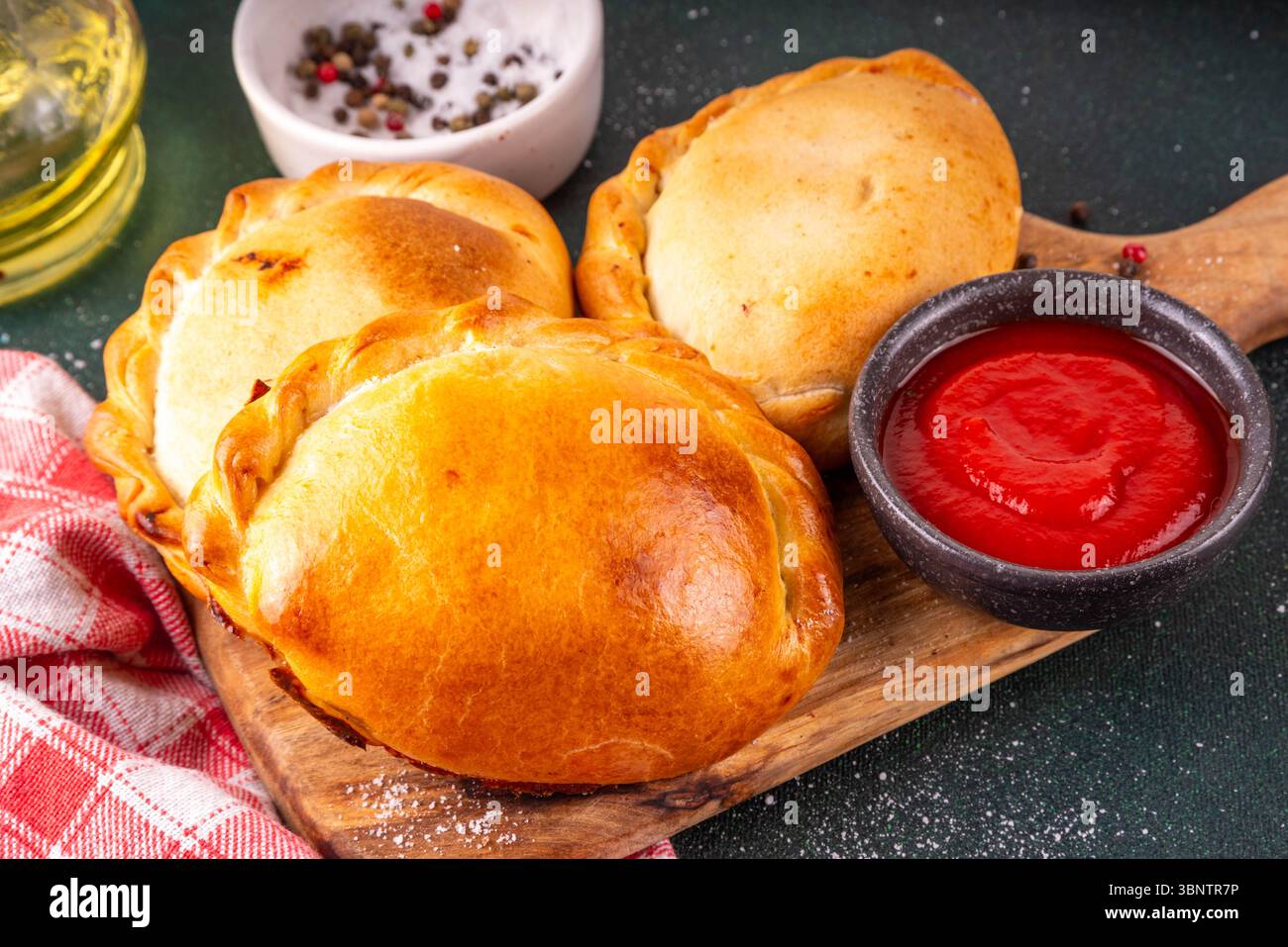 Homemade golden baked hand pies, with filling. Italian closed pizza ...