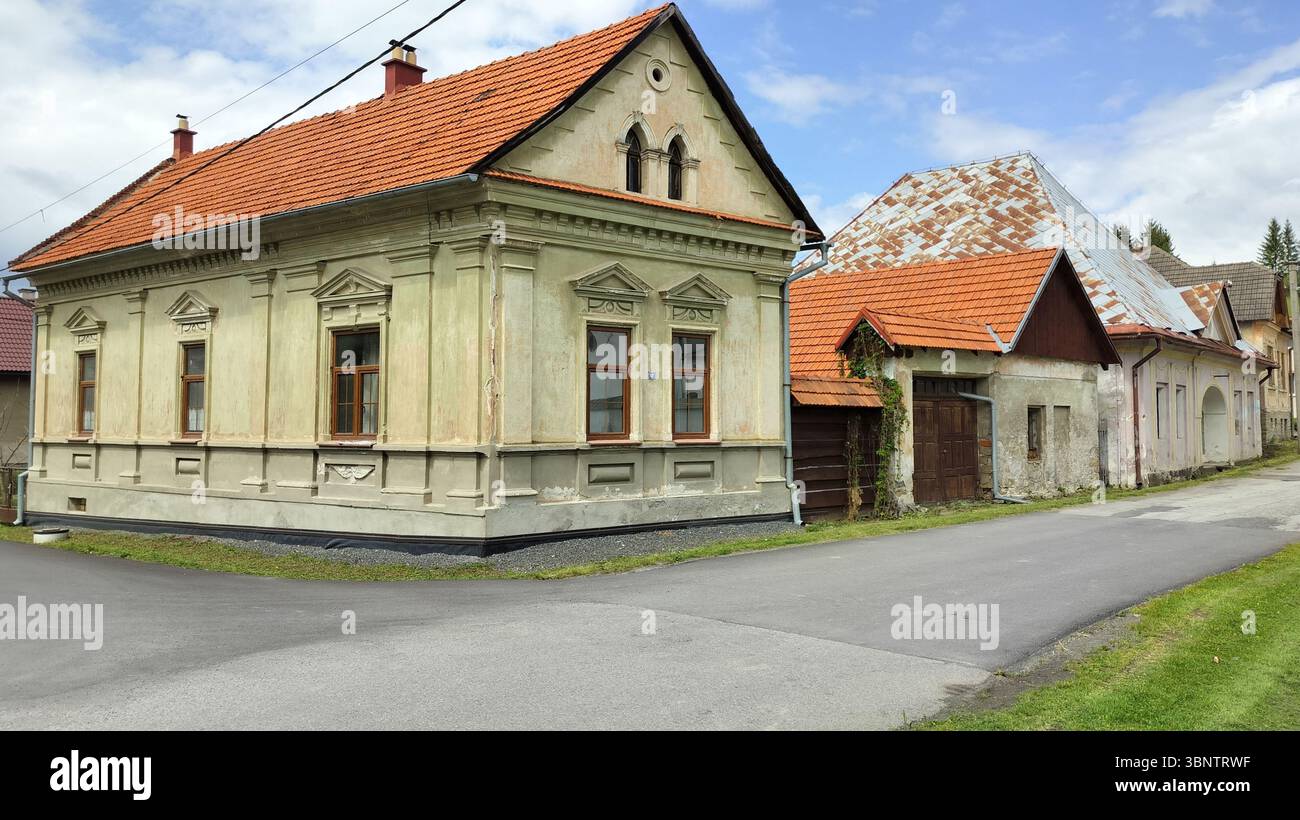 Typical townhouse with tiled roof at the intersection of village ...